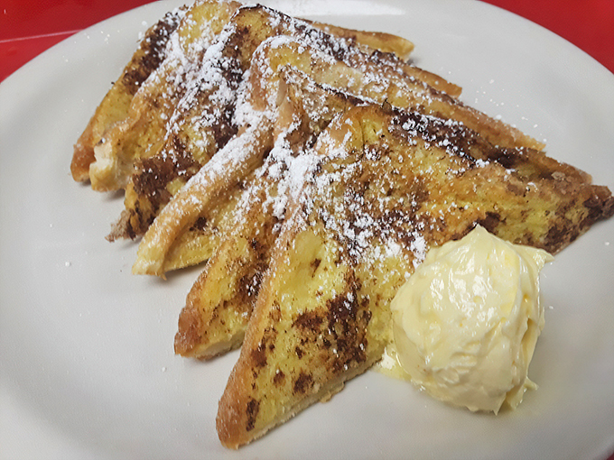 French toast that would make a Parisian weep with joy. Crispy edges, custardy center, and enough powdered sugar to make you look angelic.