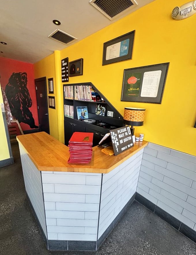 The honeycomb motif continues at this welcoming station where stacks of menus await and staff stand ready to guide you through your culinary adventure.