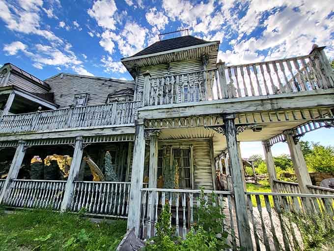 The weathered exterior in daylight reveals the impressive craftsmanship that goes into making a building look authentically haunted rather than just old and neglected.