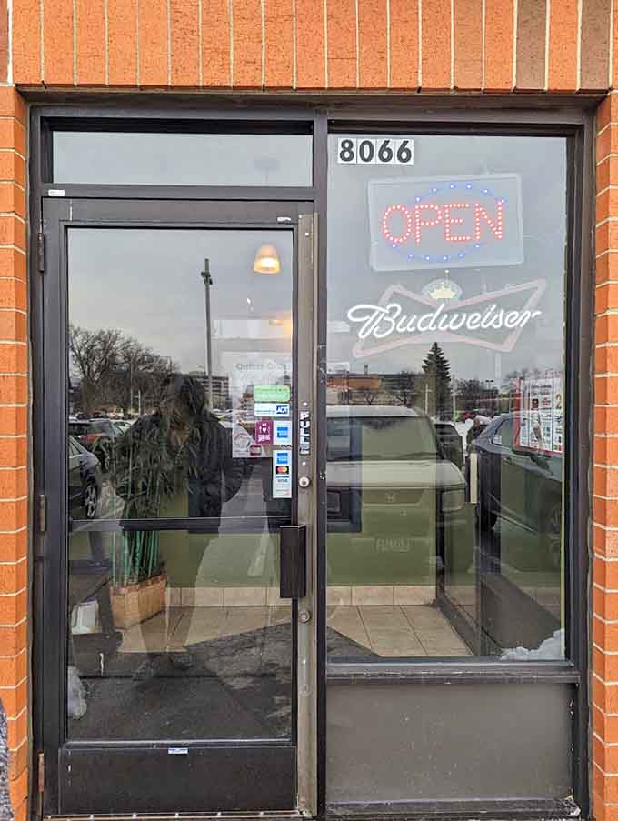 The entrance beckons with the promise of authentic flavors and genuine hospitality waiting just beyond that door you're about to open.