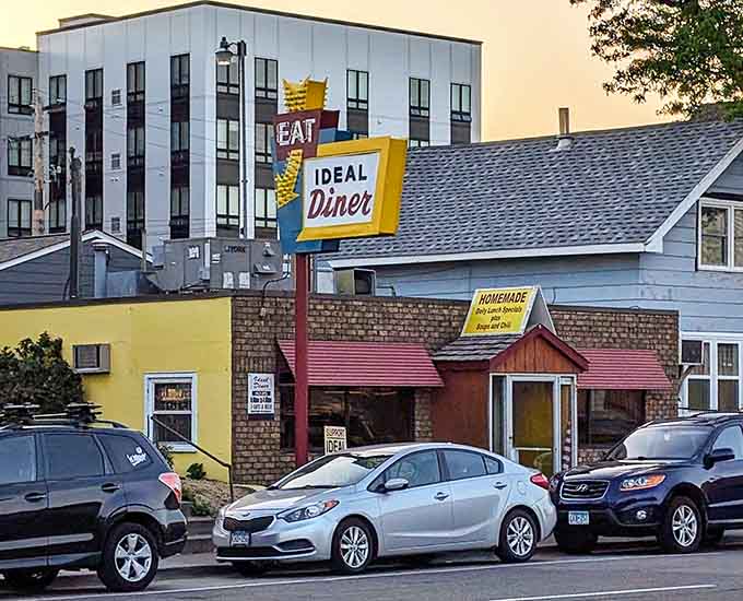 From across the street, Ideal Diner sits like a time capsule among modern buildings, proving that some things are too good to change.