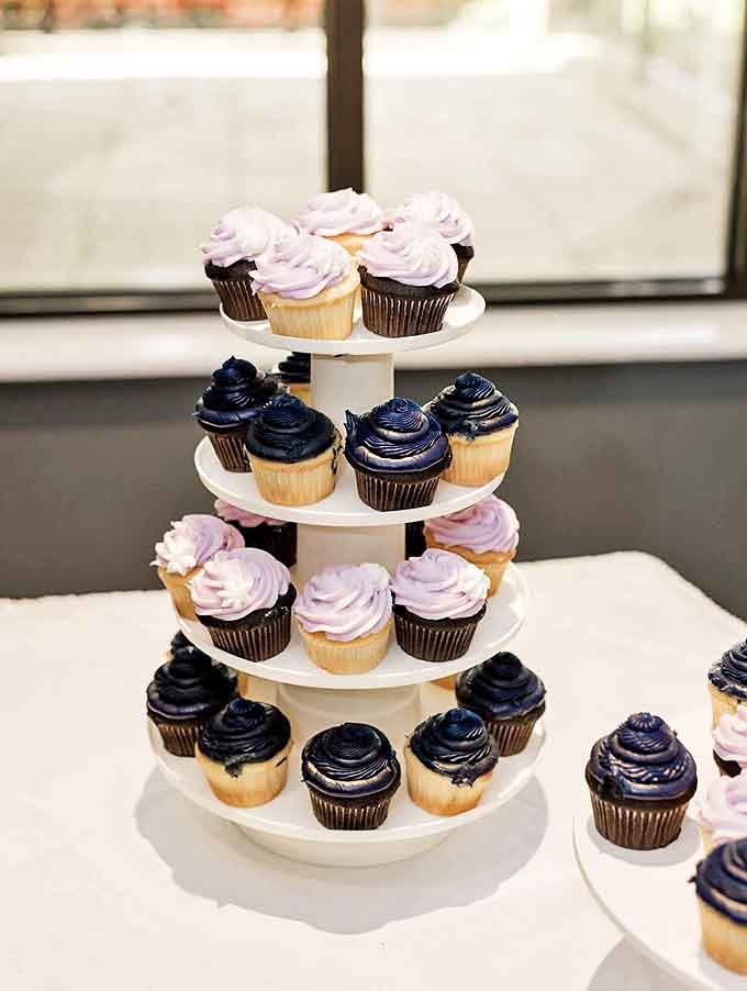 Cupcakes: A tower of frosted joy in purple and navy &ndash; proof that sometimes the best things in life come in small packages with swirled tops.