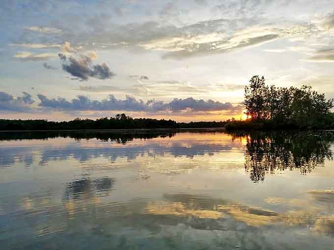 Lakeside Sunset: Nature's nightly masterpiece doubles its magic on still waters, creating the kind of moment that makes even smartphone addicts pause.