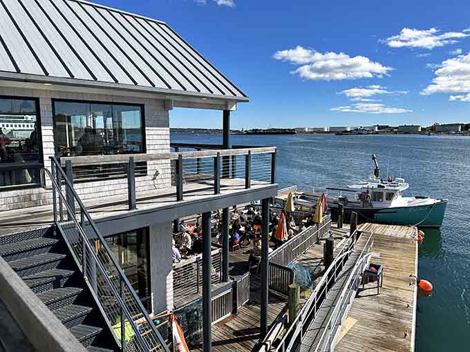 The pier stretches into the harbor like an invitation, promising fresh seafood and authentic coastal charm just steps from the water.