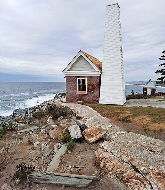 This brick fog bell house stands sentinel on the rocky coast, a reminder of the lighthouse's vital maritime history.