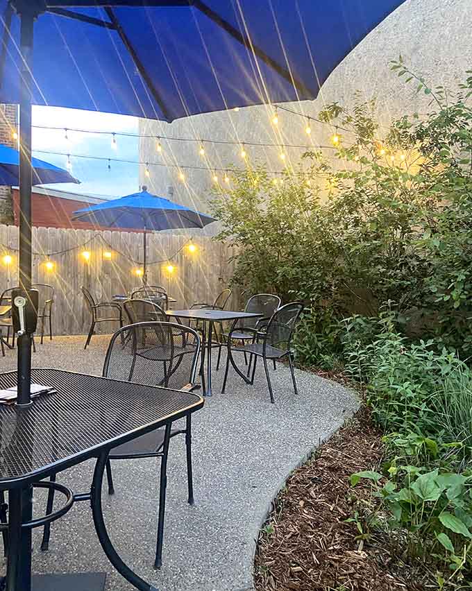 String lights and greenery transform this patio into the kind of spot where summer evenings feel magical.