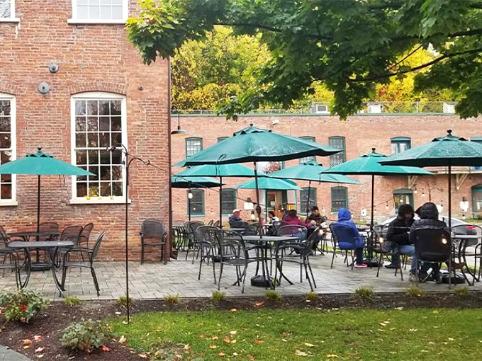 Teal umbrellas dot the brick courtyard where Vermont's fleeting perfect days are celebrated one meal at a time.