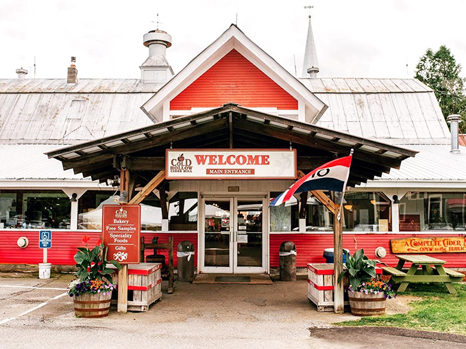 The quintessential Vermont welcome &ndash; red barn-inspired architecture with flowers that say "come in, stay awhile, and leave with more maple products than you planned."
