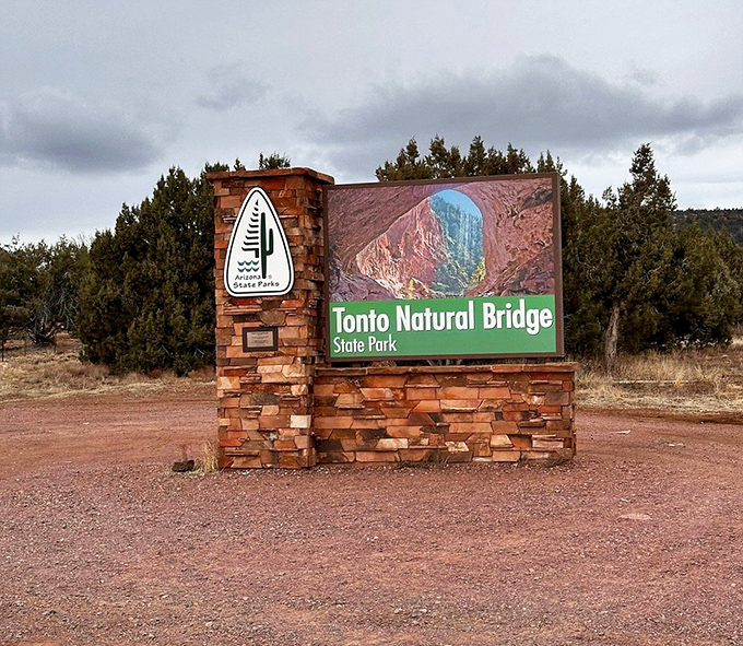 The park entrance sign stands as a humble introduction to the geological celebrity within, understating the wonder that awaits beyond.