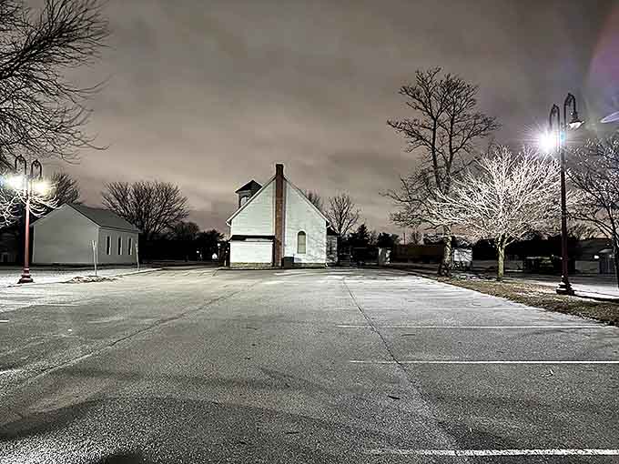 Even at night, history stands sentinel in this atmospheric view of the museum grounds, where modern lights illuminate centuries-old stories.
