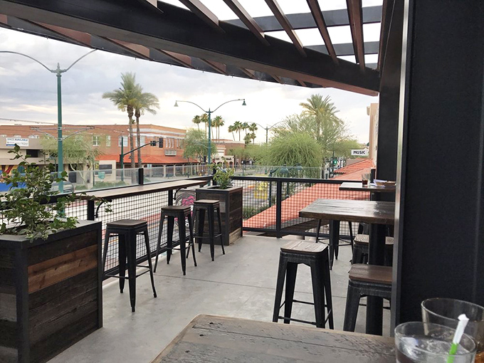 The patio at 12 West offers front-row seats to downtown Mesa's charm, where desert breezes complement cold beers perfectly.