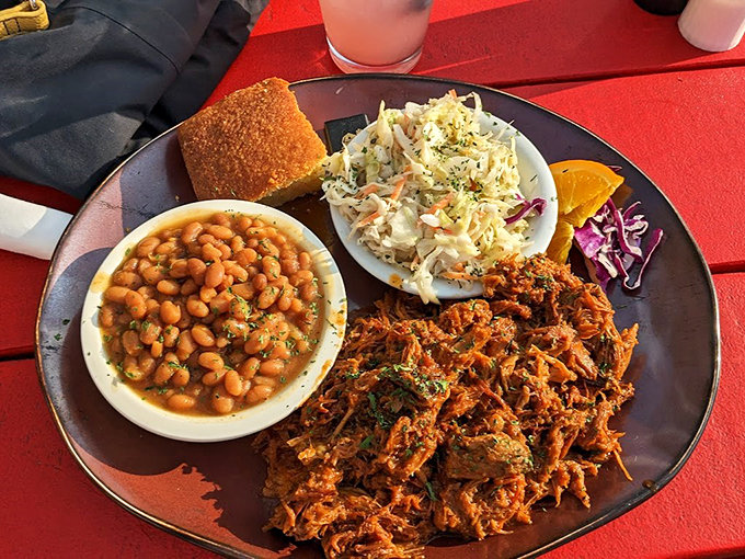 Tender pulled pork with baked beans and slaw &ndash; a plate that proves BBQ is really just love made edible.