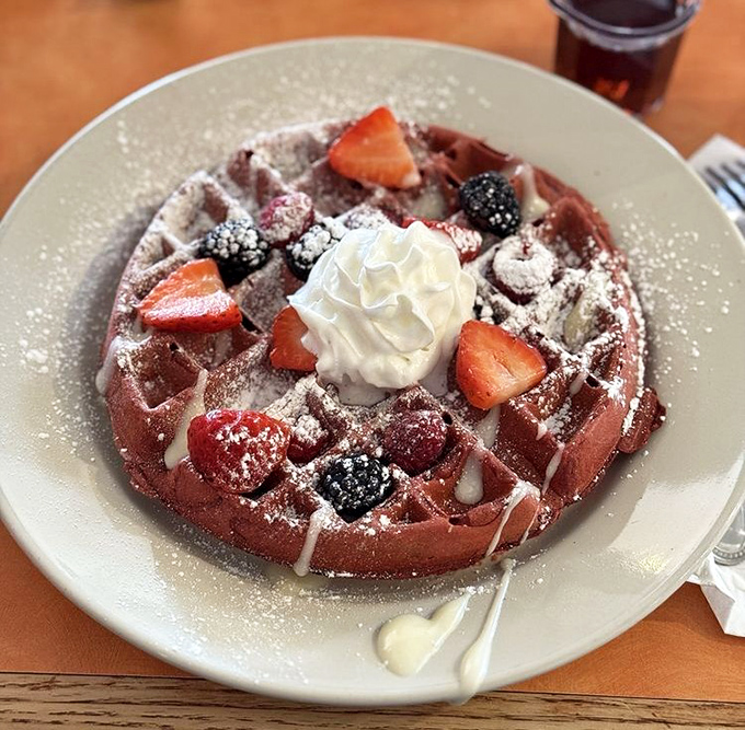 The red velvet waffle blurs the line between breakfast and dessert, topped with berries and cream for a morning indulgence worth every calorie.