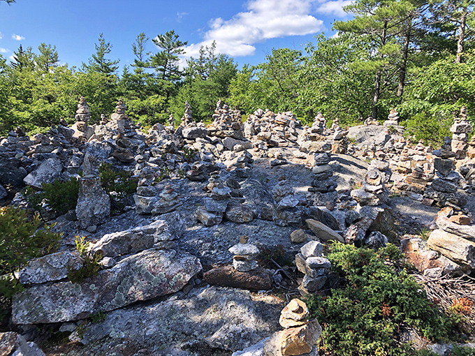 Stone cairns mark the path like a breadcrumb trail of geological confections &ndash; each stack a meditation in balance and patience.