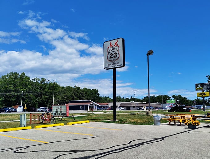 Signage: Standing tall against Michigan skies, the Route 23 sign serves as a beacon for hungry travelers seeking salvation through smoke and sauce.