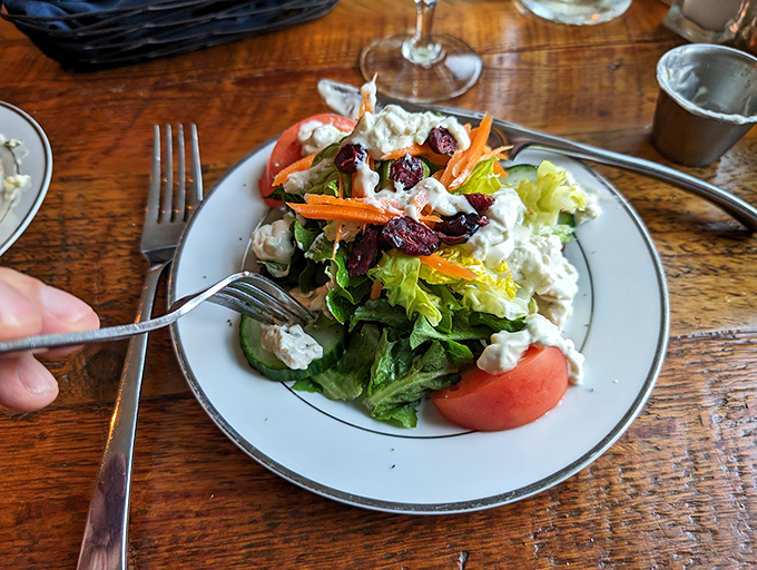 A vibrant salad brings color and freshness to the table &ndash; proof that even the simplest dishes receive star treatment here.