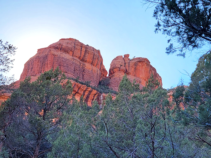The sun sets on Sedona's secret, painting the sky in hues that would make even Bob Ross reach for his palette. It's nature's own light show!