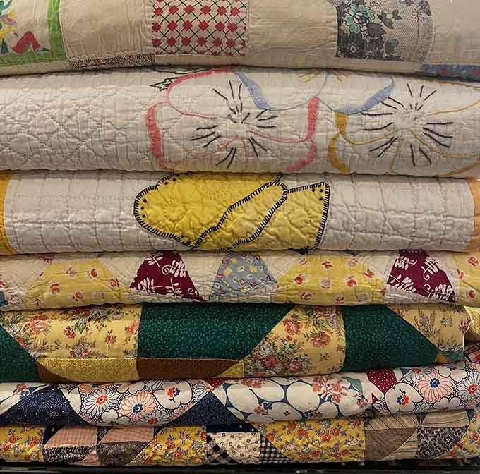 Hand-stitched quilts showcase incredible craftsmanship and patience, each one representing countless hours of careful work by talented hands long gone.