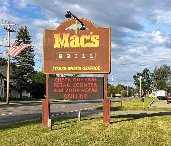 The iconic Mac's Grill sign stands as a beacon for hungry travelers, promising steaks, spirits, and seafood worth the journey.