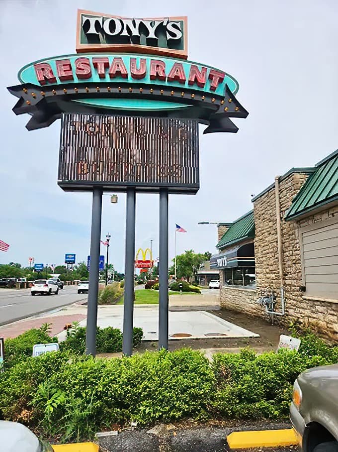 The vintage signage stands tall against the Michigan sky, a landmark that's guided generations of hungry travelers to portion paradise.