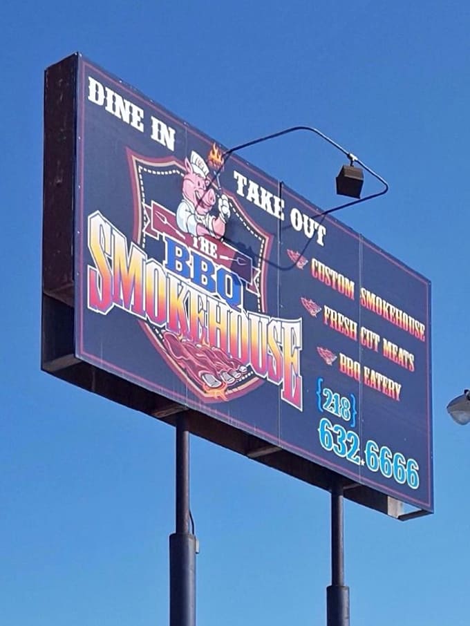 That cheerful pig mascot on the sign knows what's up, inviting everyone to experience some serious smokehouse magic.