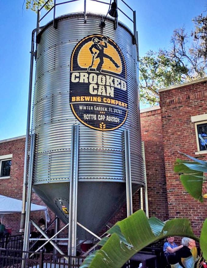The iconic Crooked Can silo stands tall outside the brewery, a beacon for craft beer lovers seeking quality brews in Winter Garden.