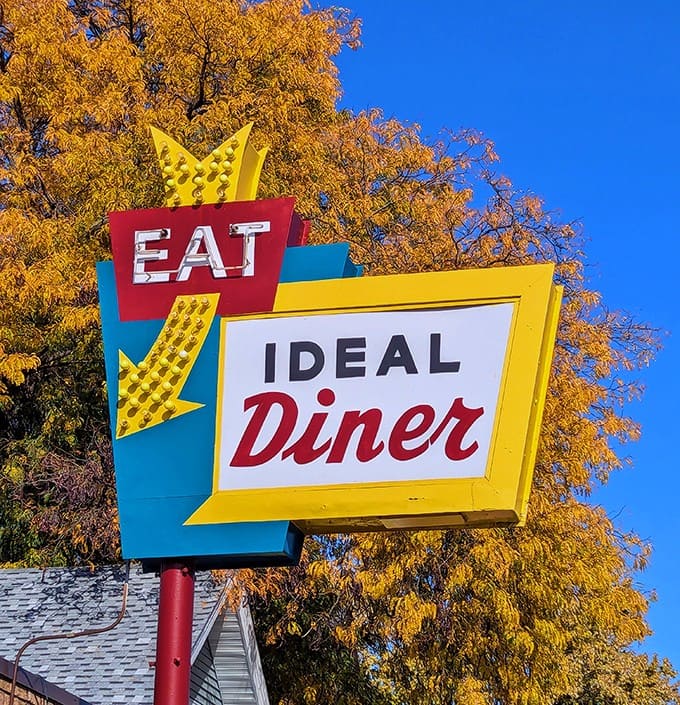 That classic sign against autumn leaves or blue sky never fails to catch the eye, a colorful promise of the comfort food waiting inside this beloved breakfast institution.