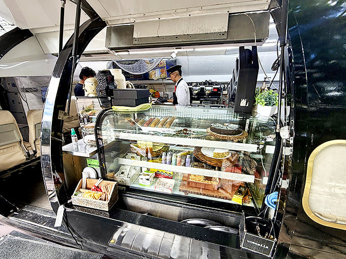 Pastries and light bites tempt from behind glass, arranged with the same care that goes into packing a perfectly balanced cargo hold.