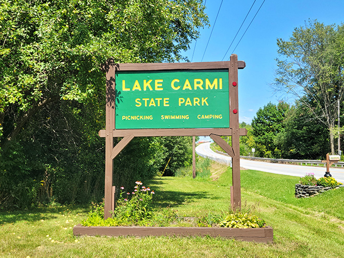 The most honest advertising in tourism: Lake Carmi State Park's sign promises simple pleasures that somehow feel extraordinary once experienced.