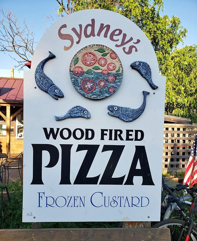 The sign says it all: wood-fired pizza and frozen custard, with whimsical fish decorations that capture the North Shore spirit perfectly.