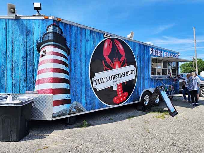 The full view of The Lobstah Buoy in its natural habitat, where that distinctive blue exterior and lobster logo have become a beloved landmark for seafood lovers.