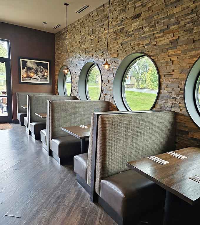 Booth seating with circular windows adds character and charm, making every meal feel a little more special than ordinary.