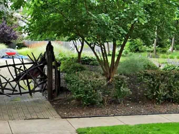 This artistic gateway of twisted branches marks the threshold between ordinary space and the realm of creative wonder beyond.