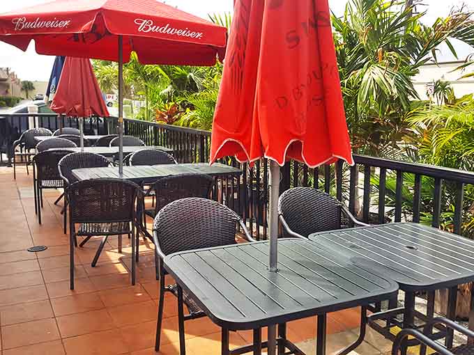 The outdoor patio offers al fresco dining under Florida's famous sunshine. Red umbrellas provide shade while you enjoy the Gulf breeze with your seafood feast.