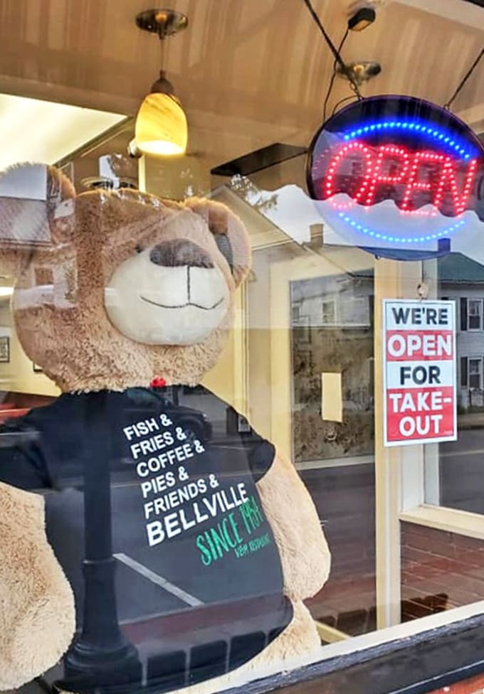 The glowing "OPEN" sign and friendly mascot bear promise more than just a meal &ndash; they're an invitation to become part of the V&M family.