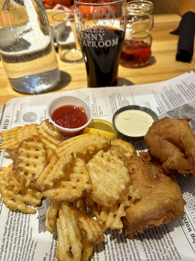 The ultimate comfort food trio: crispy battered fish, golden fries, and dipping sauces worth every bite.