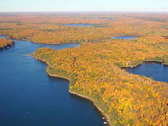 Fall's fiery palette transforms the Northwoods into a tapestry of color, with Black Oak Lake the sapphire centerpiece.