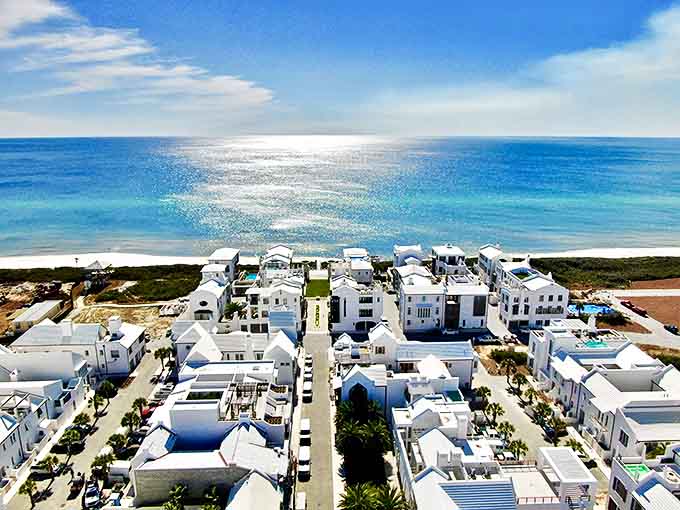 Aerial view: From above, Alys Beach reveals its perfect symmetry, a brilliant white chess board of luxury homes strategically placed between emerald forest and azure sea.