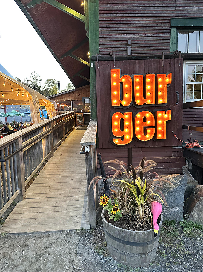 The illuminated "burger" sign glows against the Vermont twilight, a beacon of hope for travelers who understand that sometimes the best meals happen in the most unexpected places.