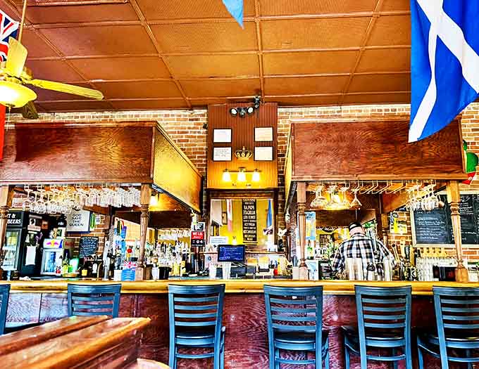 The inviting bar counter, where locals and visitors alike gather to share stories and savor pints under international flags.