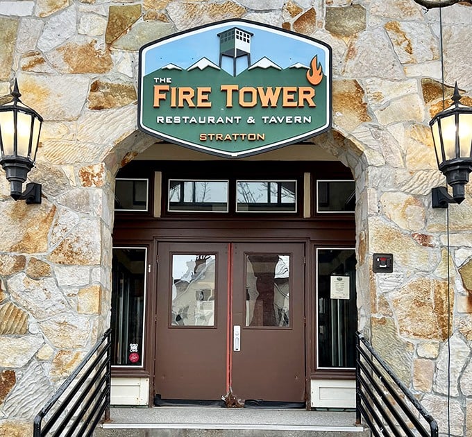 Stone and timber frame the entrance to Fire Tower, promising an authentic Vermont dining experience that lives up to the Green Mountain State's reputation.