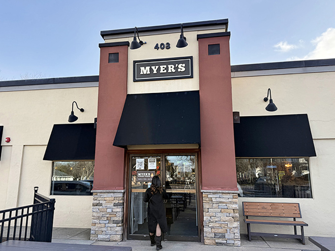 The entrance to Myer's Wood Fired welcomes visitors with stone accents and black awnings&mdash;a portal to a world of smoky, doughy delights.