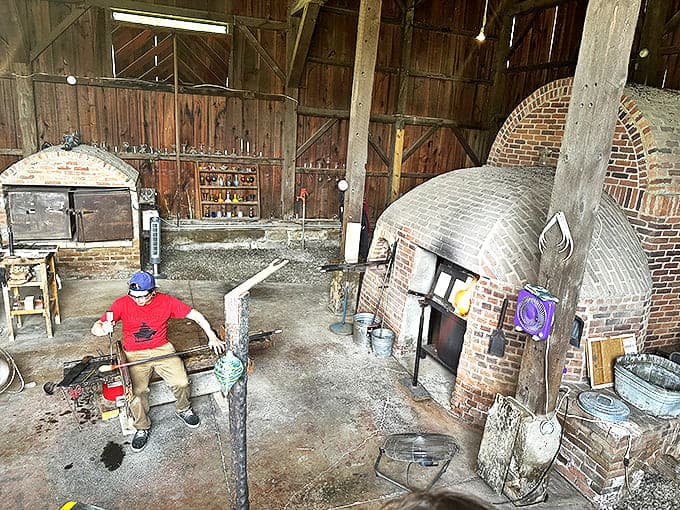 A craftsman works his magic in the glassblowing studio, transforming molten glass into art through techniques unchanged since ancient times.