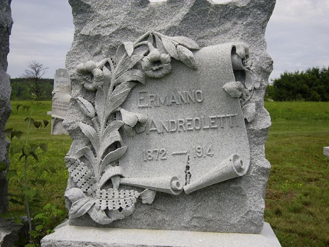 Delicate stone flowers and scrollwork adorn this monument, showing how even the hardest granite can appear soft in a master's hands.