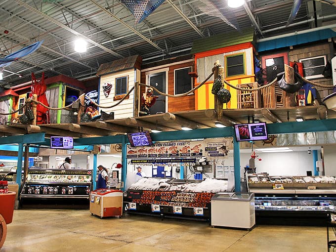 Fishing village-themed seafood section transforms shopping into coastal exploration, complete with tiny houses perched above fresh catch displays.