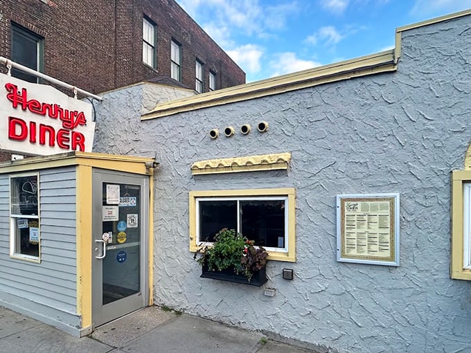 The blue-gray exterior with cheerful yellow trim stands as a beacon of breakfast hope on Burlington's streetscape. Some landmarks don't need to be tall to be significant.