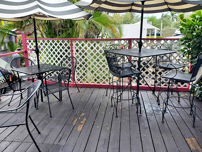 The outdoor dining area offers a tranquil setting for enjoying Caribbean-inspired cuisine under the Florida sky.