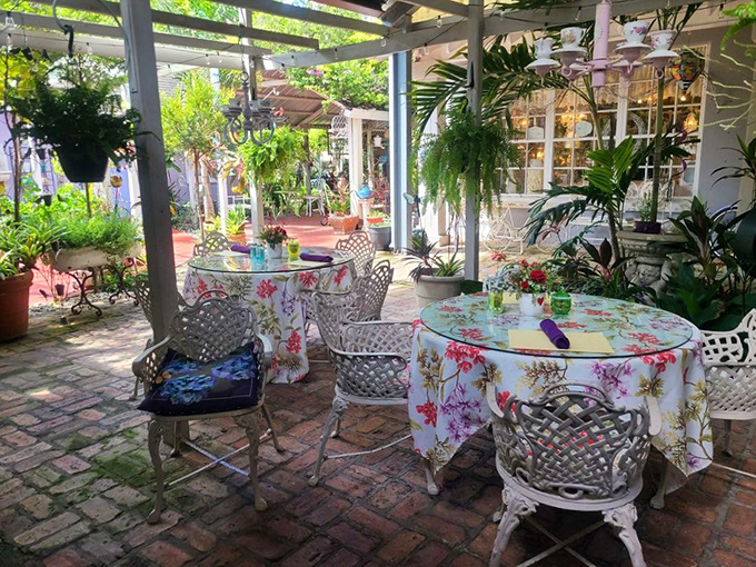 The garden patio invites al fresco dining among flowering plants and dappled sunlight &ndash; Florida weather at its most accommodating.