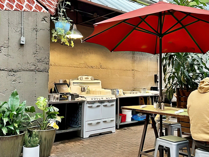 A vintage stove adds nostalgic charm to the outdoor space, hinting at Crema's blend of traditional cooking methods and modern culinary creativity.