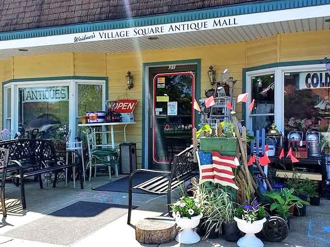 The exterior display hints at the treasures within &ndash; garden items, Americana, and seasonal decor spilling out onto the welcoming porch.